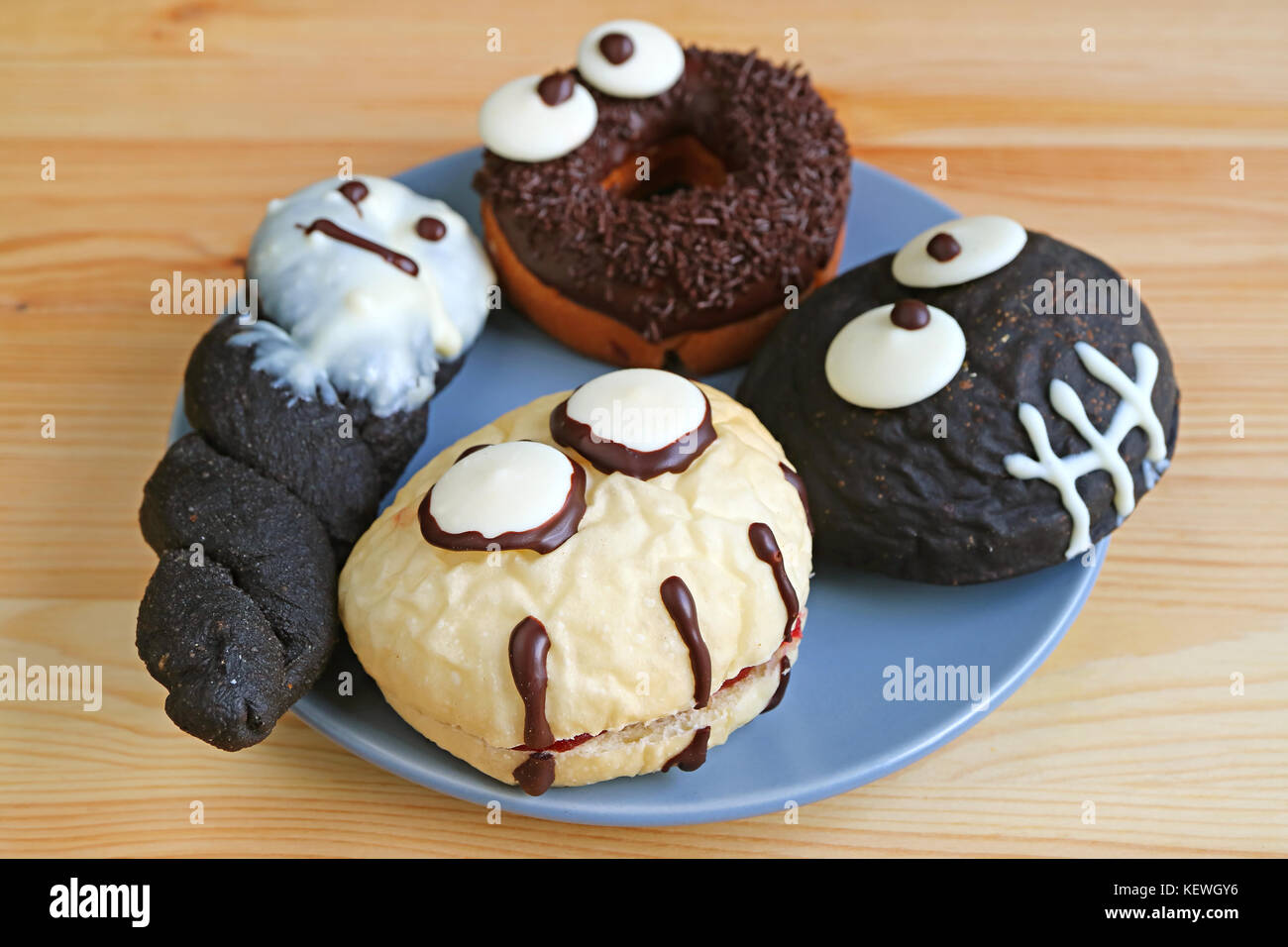 Plate of Assorted Halloween Monsters and Ghosts Shaped Doughnuts Served ...