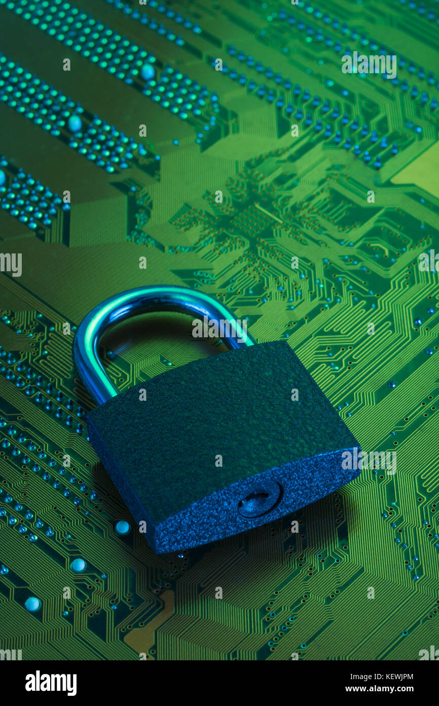 Close-up of small padlock on electronic circuitboard. For cyber ...