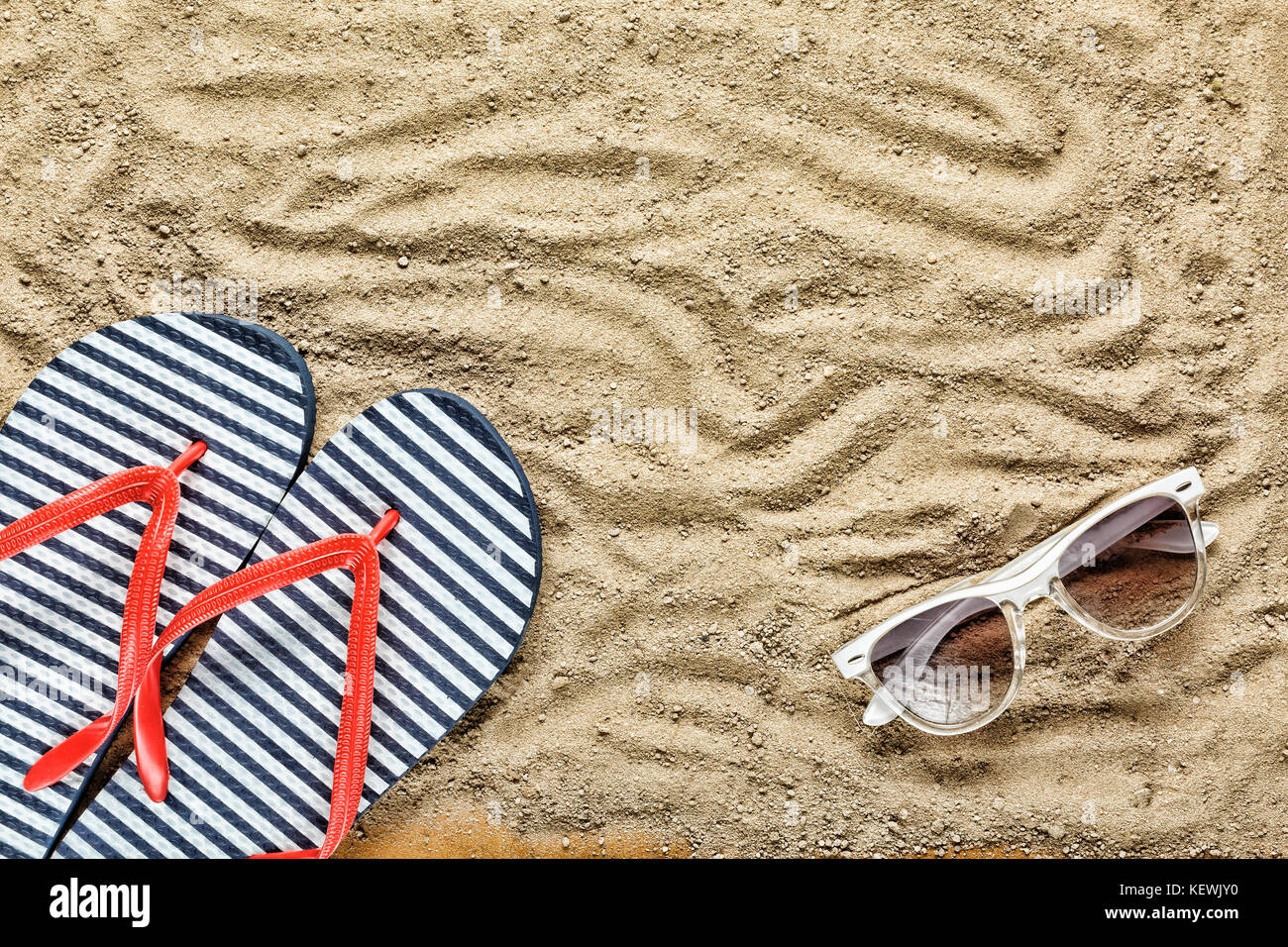 Beach background. Beach slippers and sunglasses on the seashore, golden ...