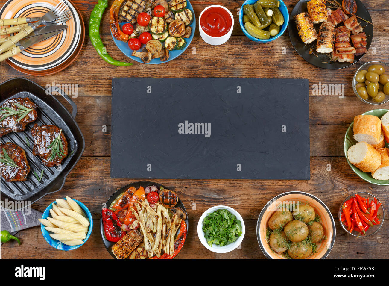 Dinner table. Various snacks of grill and barbecue on a wooden table ...