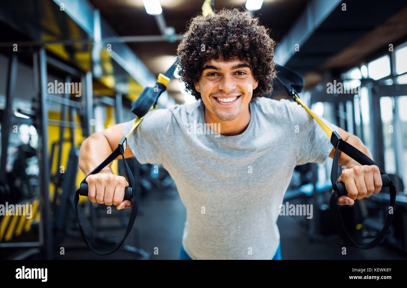 Young handsome man doing exercises in gym Stock Photo - Alamy