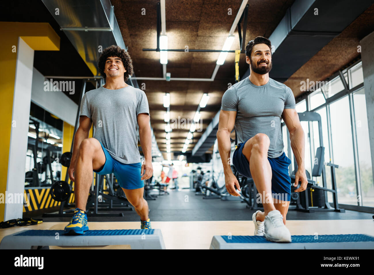 Group of young people doing exercises in gym Stock Photo - Alamy