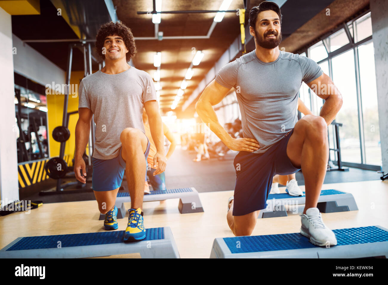 Group of young people doing exercises in gym Stock Photo - Alamy