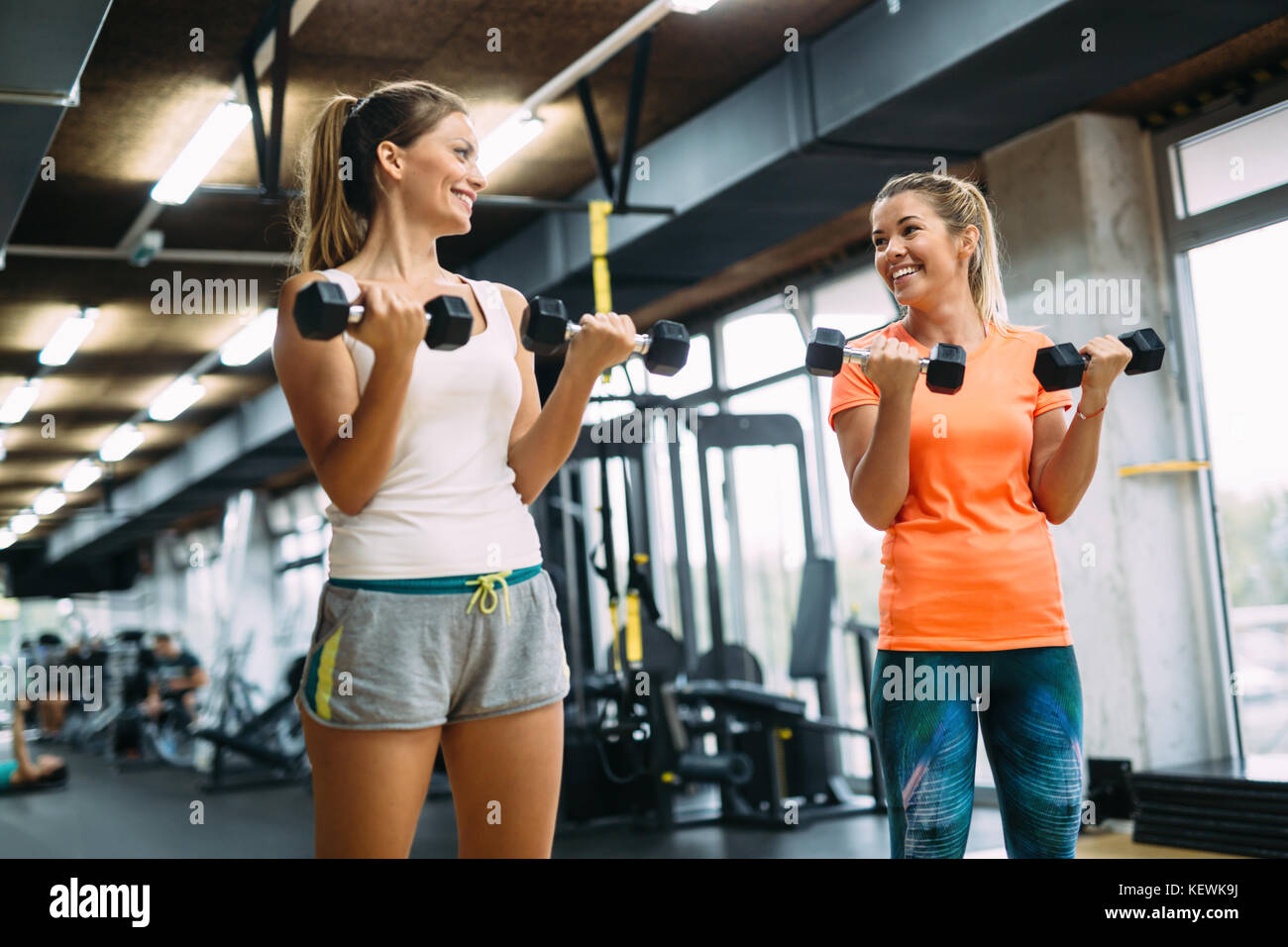 Young women doing exercises in gym together Stock Photo - Alamy