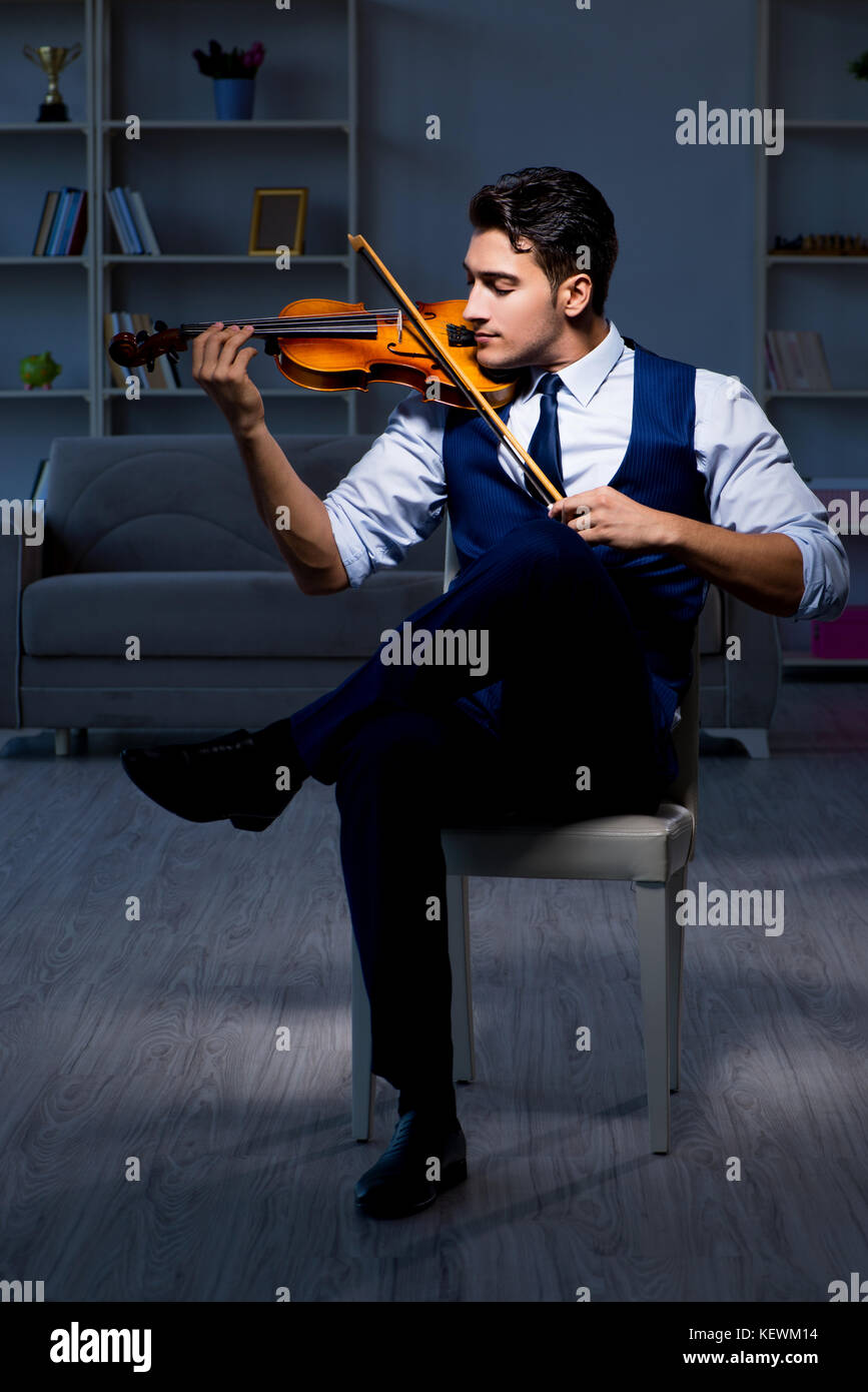 Young musician man practicing playing violin at home Stock Photo - Alamy