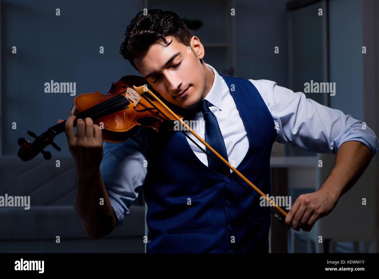 Young musician man practicing playing violin at home Stock Photo - Alamy