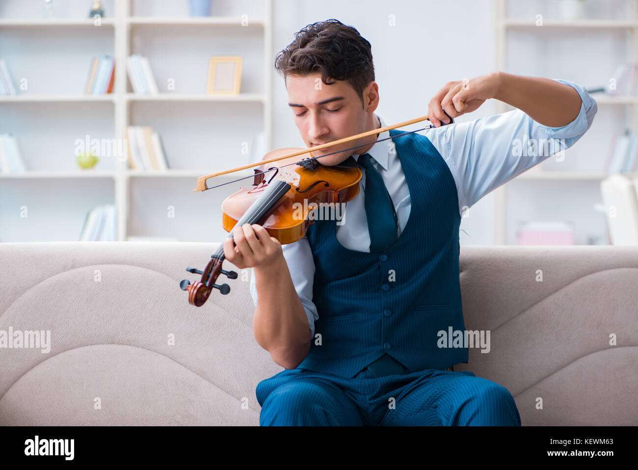 Young musician man practicing playing violin at home Stock Photo - Alamy