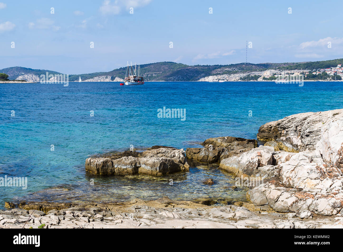 Limestone rocks jut out into the blue waters off the island of Jerolim ...