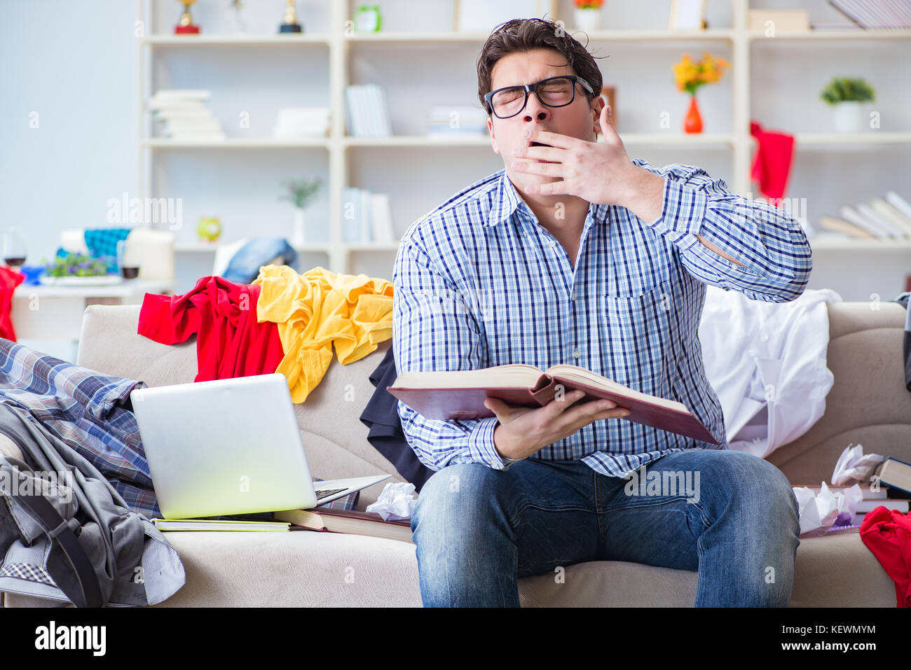 Young man working studying in messy room Stock Photo - Alamy
