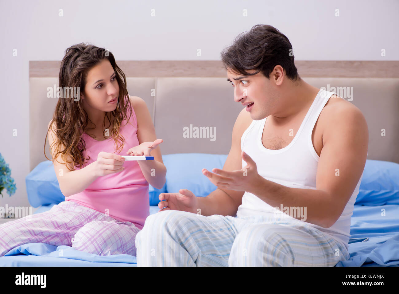 Young family with pregnancy test results Stock Photo - Alamy