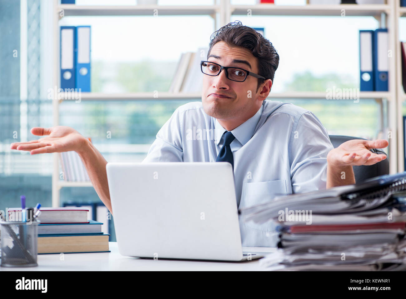 Businessman with excessive work paperwork working in office Stock Photo ...