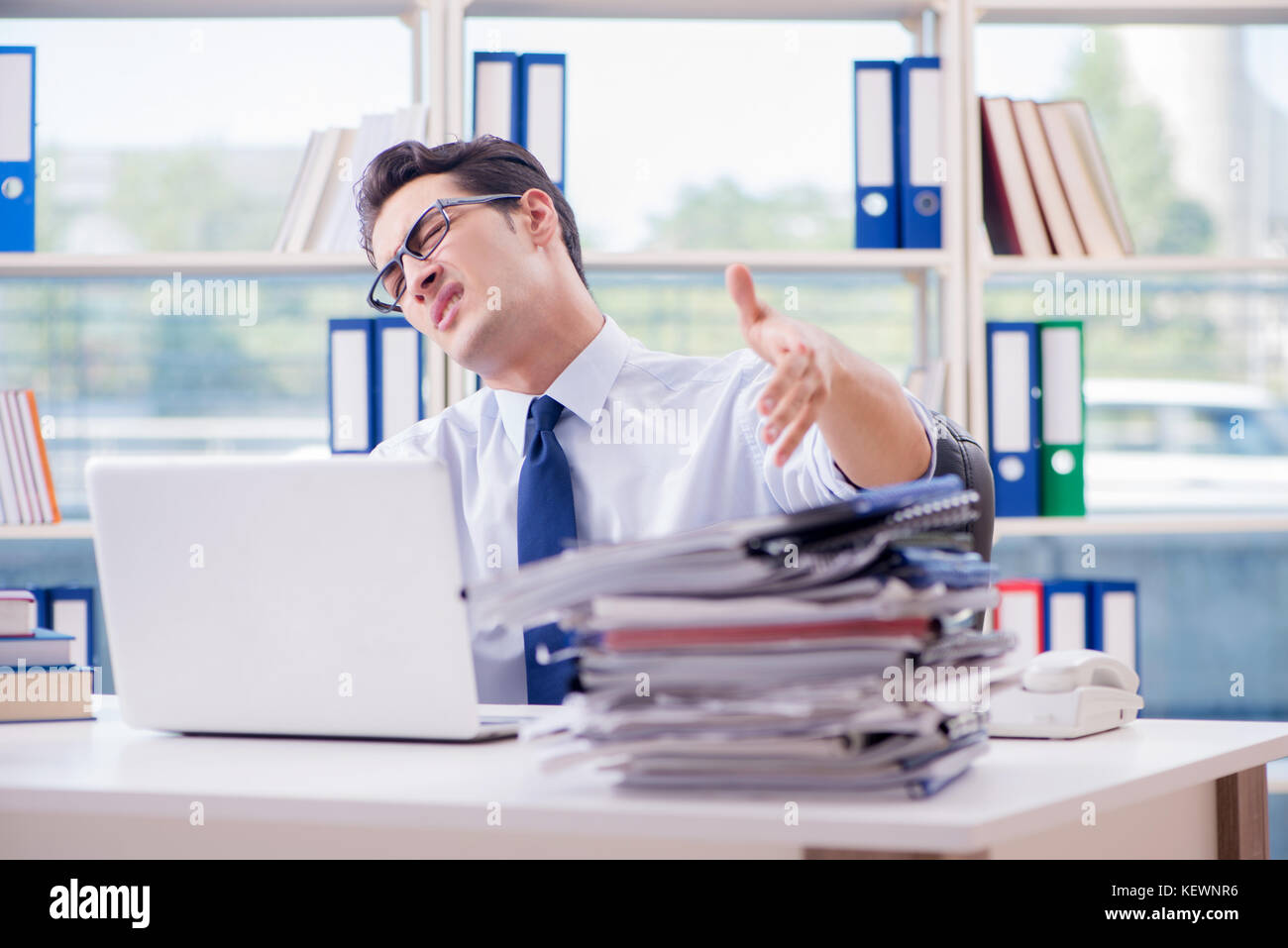 Businessman with excessive work paperwork working in office Stock Photo ...