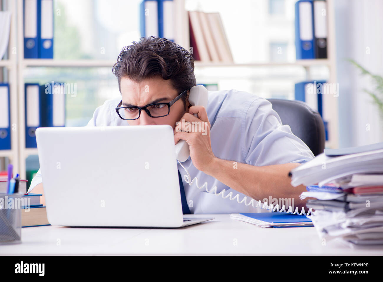 Businessman with excessive work paperwork working in office Stock Photo ...