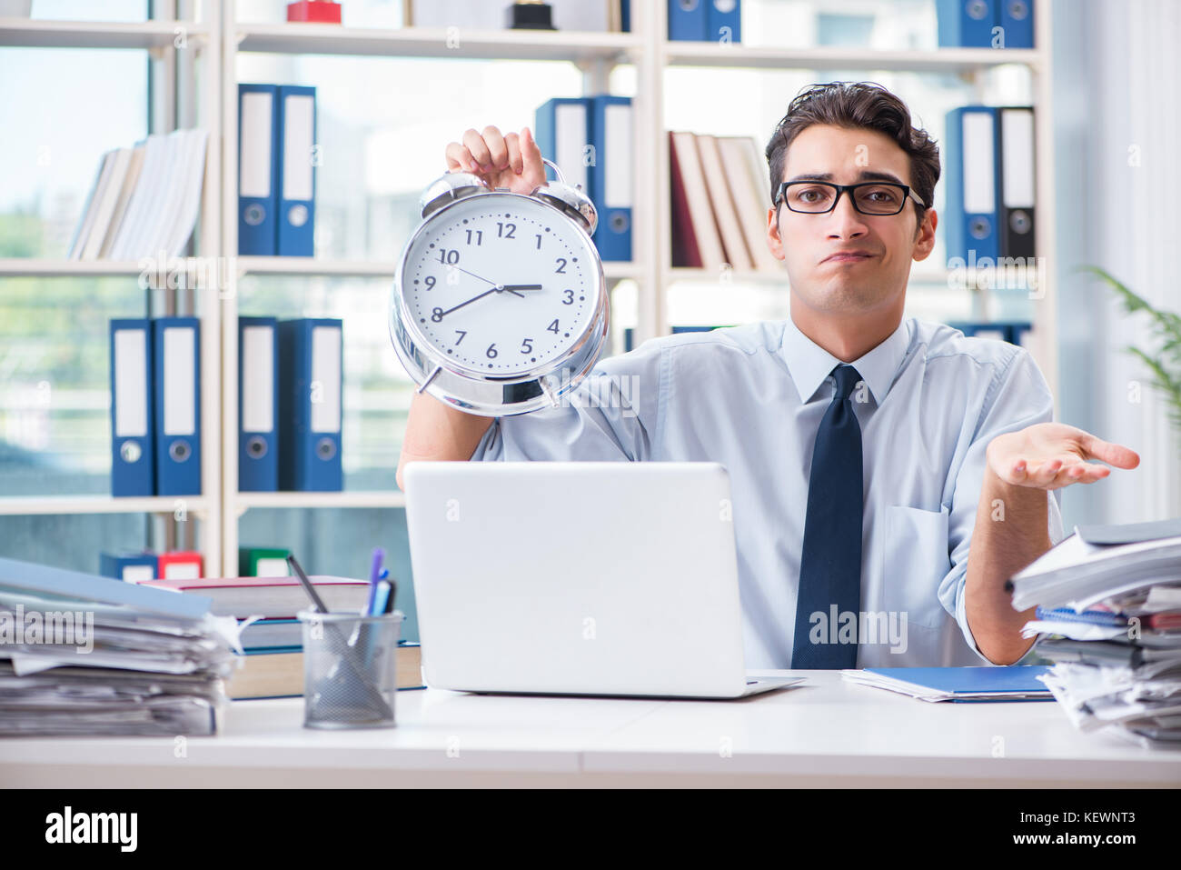Businessman missing deadline for deliverables in office Stock Photo - Alamy