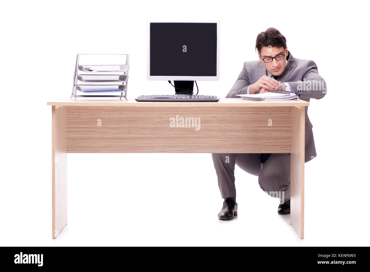 Businessman hiding in the office isolated on white Stock Photo - Alamy