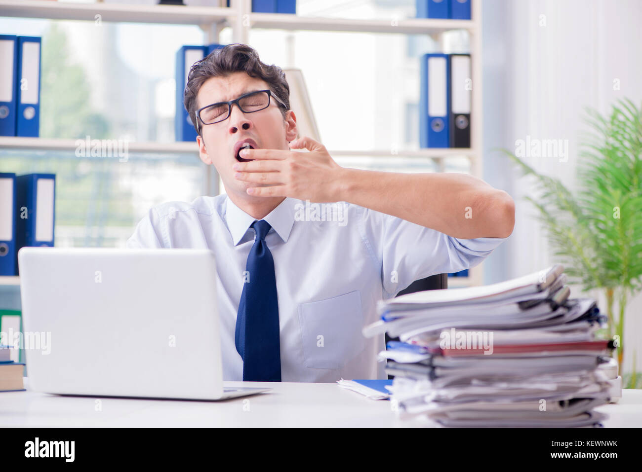 Tired exhausted businessman sitting in the office Stock Photo - Alamy