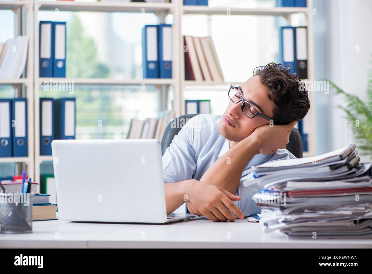 Tired exhausted businessman sitting in the office Stock Photo - Alamy