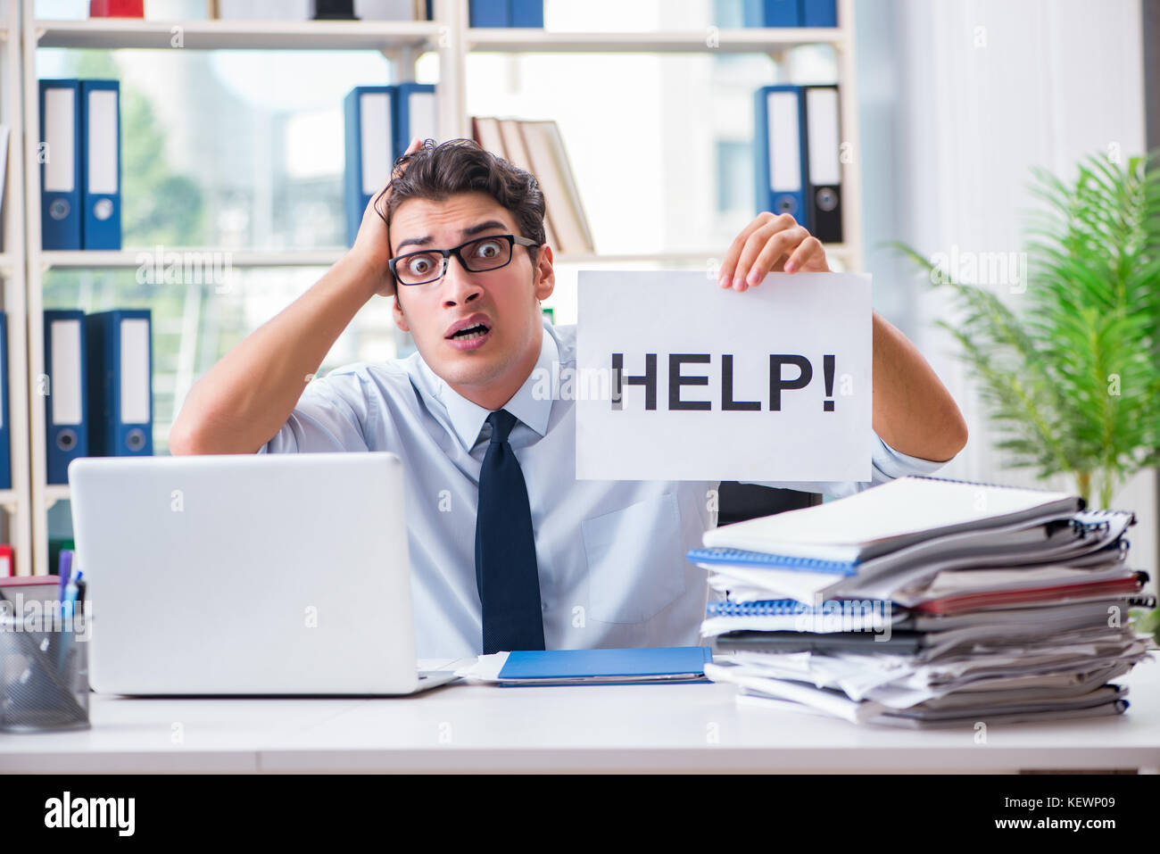 Young businessman asking for help in office Stock Photo - Alamy