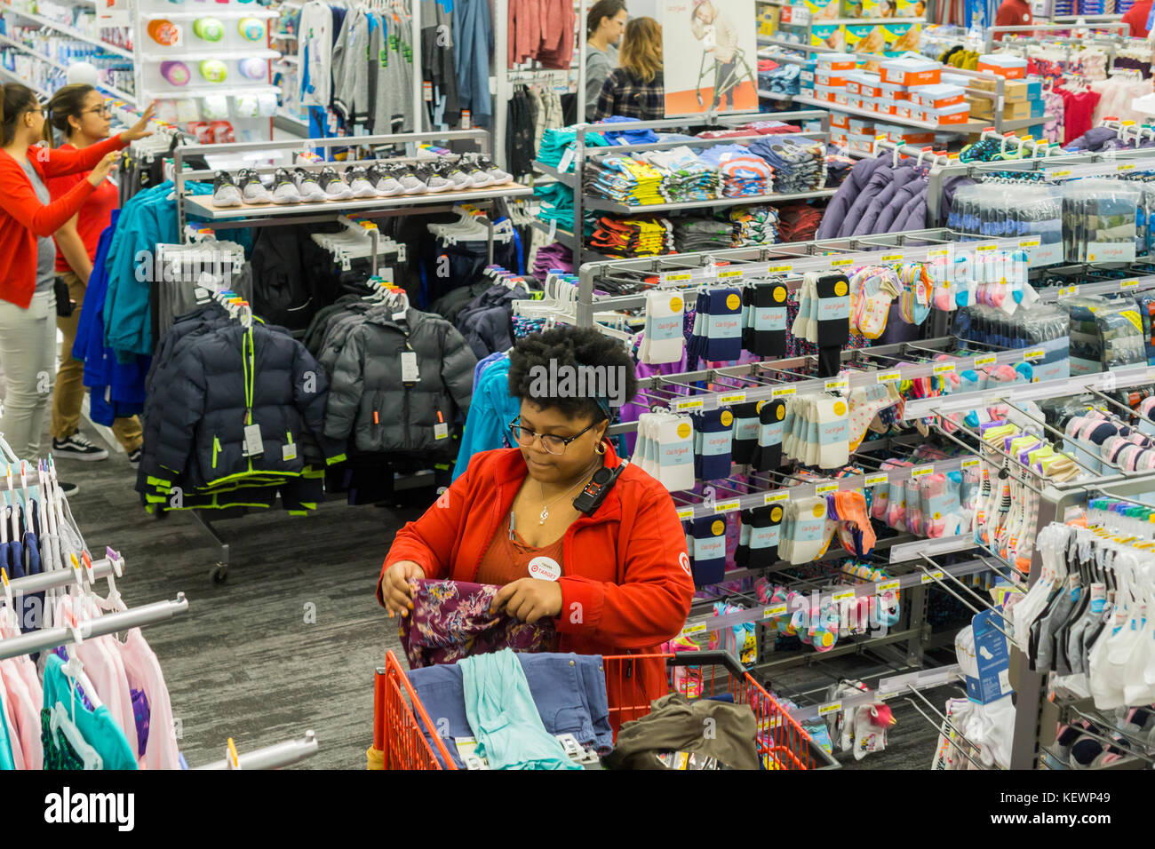 A worker arranges merchandise in a Target store in Herald Square in New ...