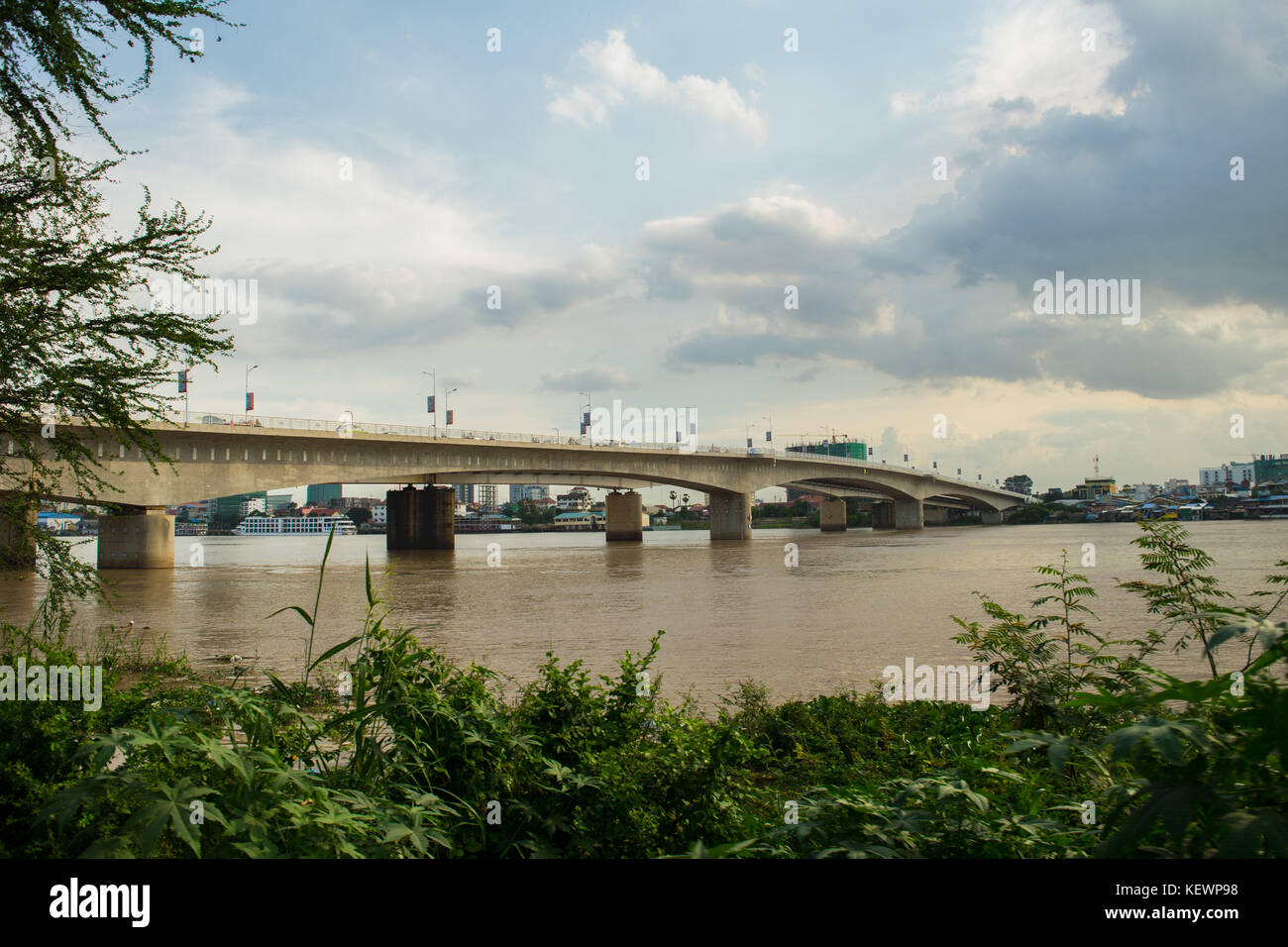 Cambodian japanese friendship bridge surrounded by slums and vegetation ...