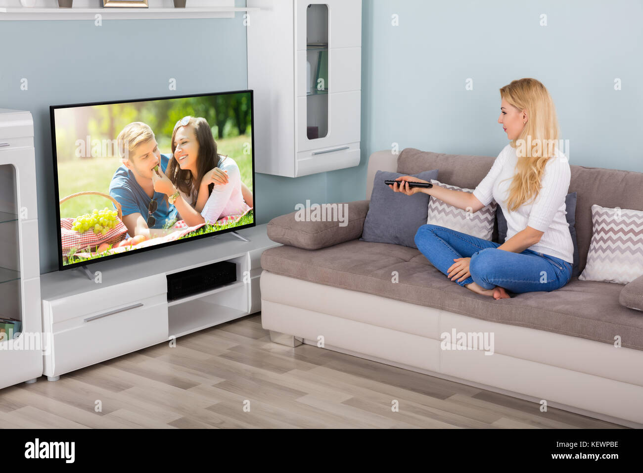 Young Woman Watching Movie On Television At Home Stock Photo - Alamy