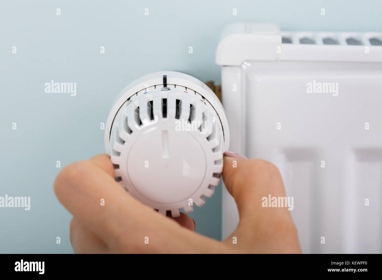 Close-up Of Woman's Hand Adjusting Radiator Thermostat Valve At Home ...