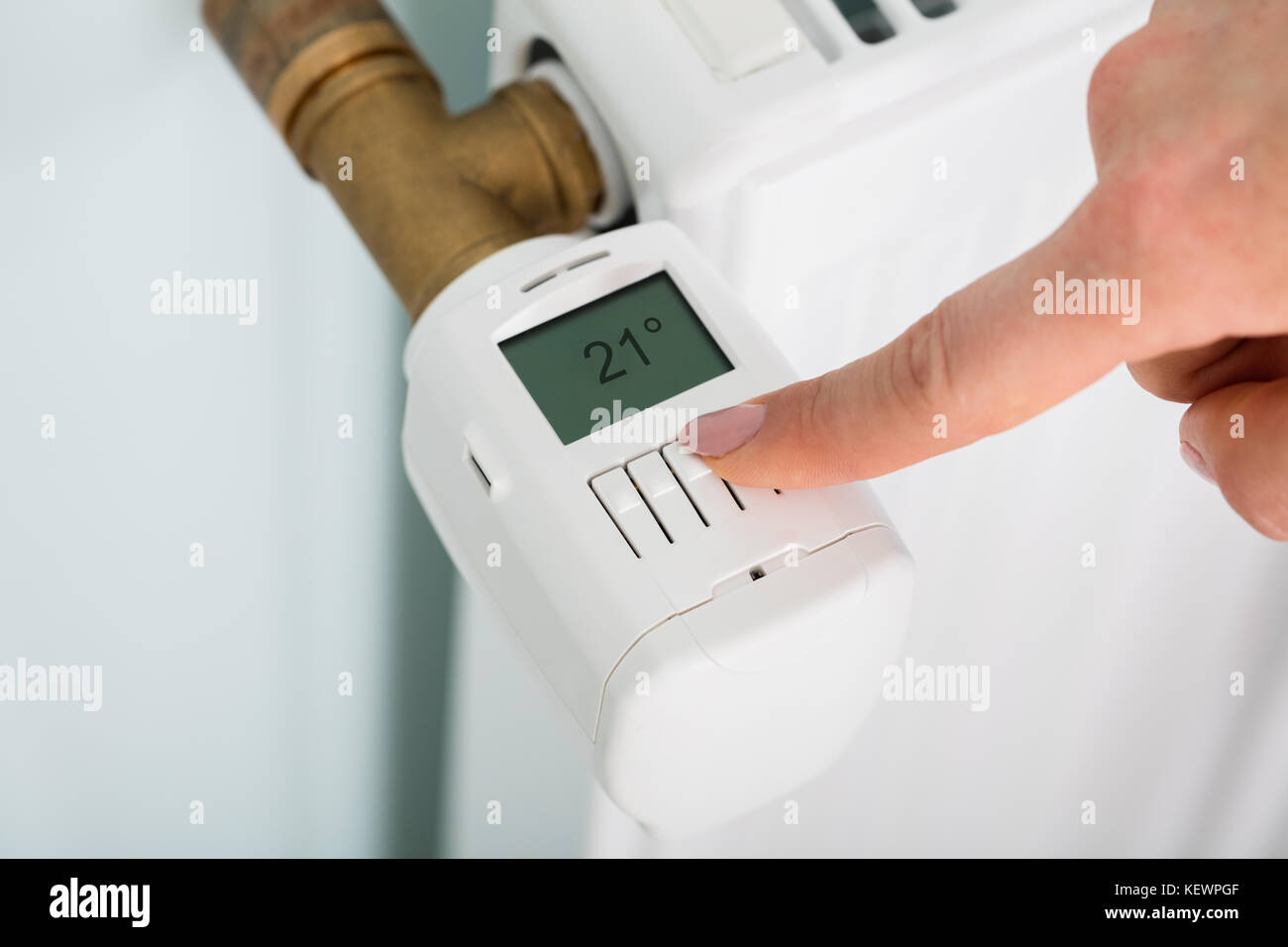 High Angle View Of Person Hand Adjusting Temperature On Thermostat ...