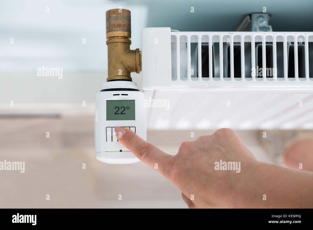 High Angle View Of Person Hand Adjusting Temperature On Thermostat ...
