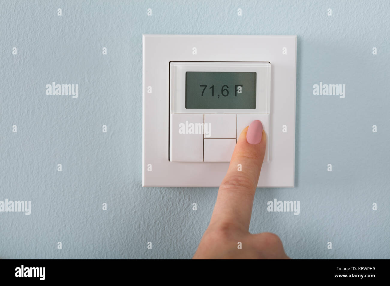 Close-up Of Person Hand Setting The Thermostat At House Stock Photo - Alamy