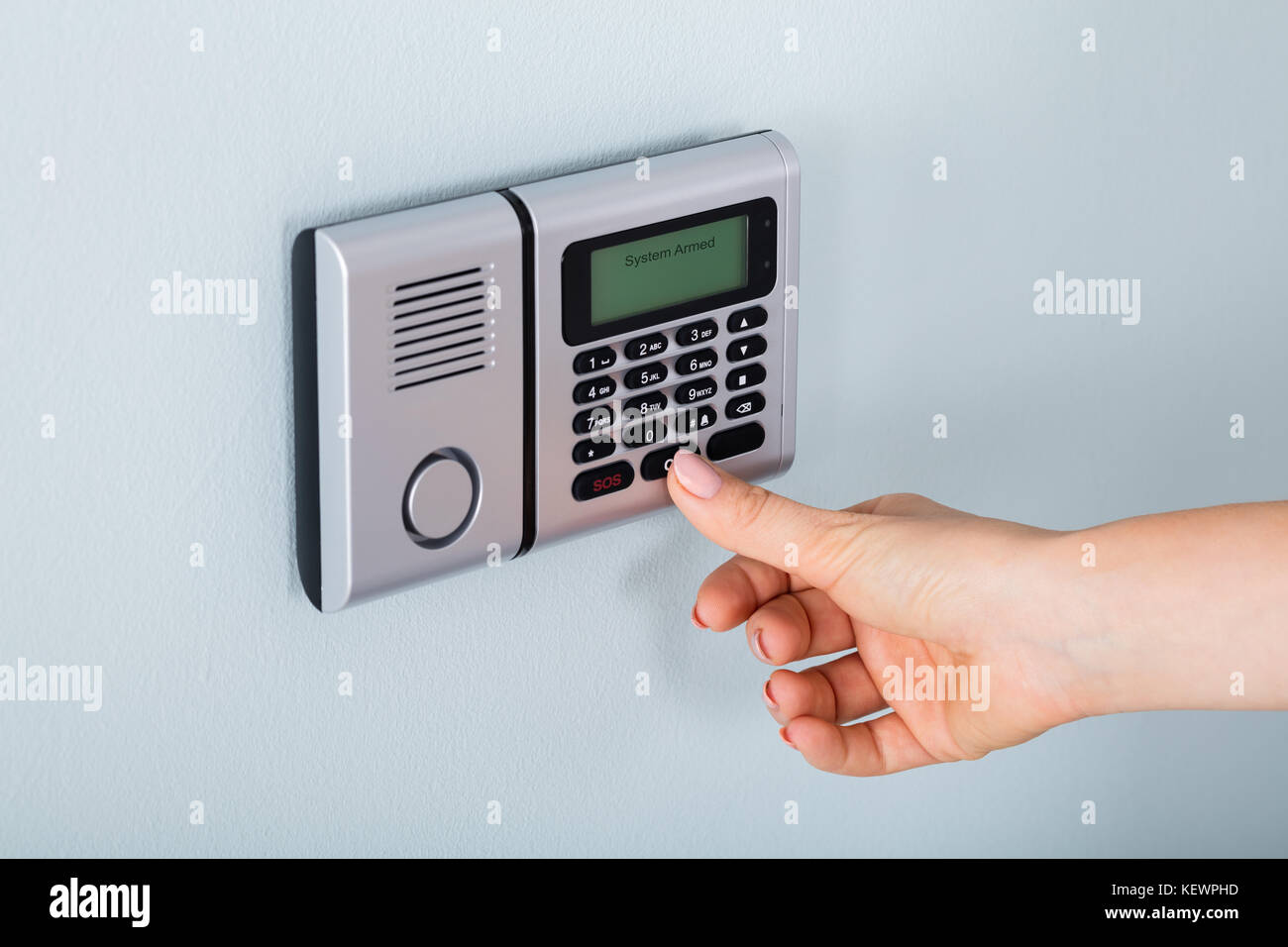 Close-up Of Person Hand Entering Code On Keypad Of Home Security Alarm ...