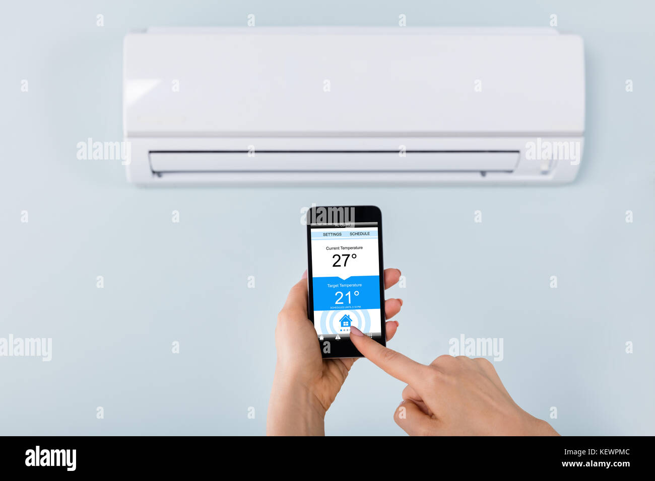 Close-up Of Person Hand Setting Temperature Of Air Conditioner Using ...