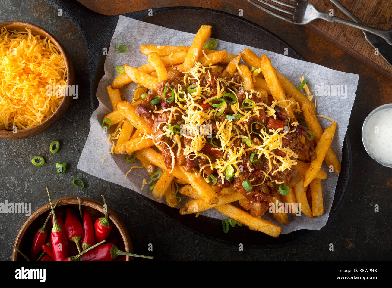 Delicious homemade spicy chili fries with green onion and cheddar ...
