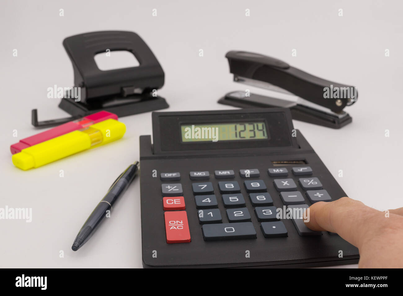 Office desktop calculator stapler punch pens marker hand Stock Photo ...