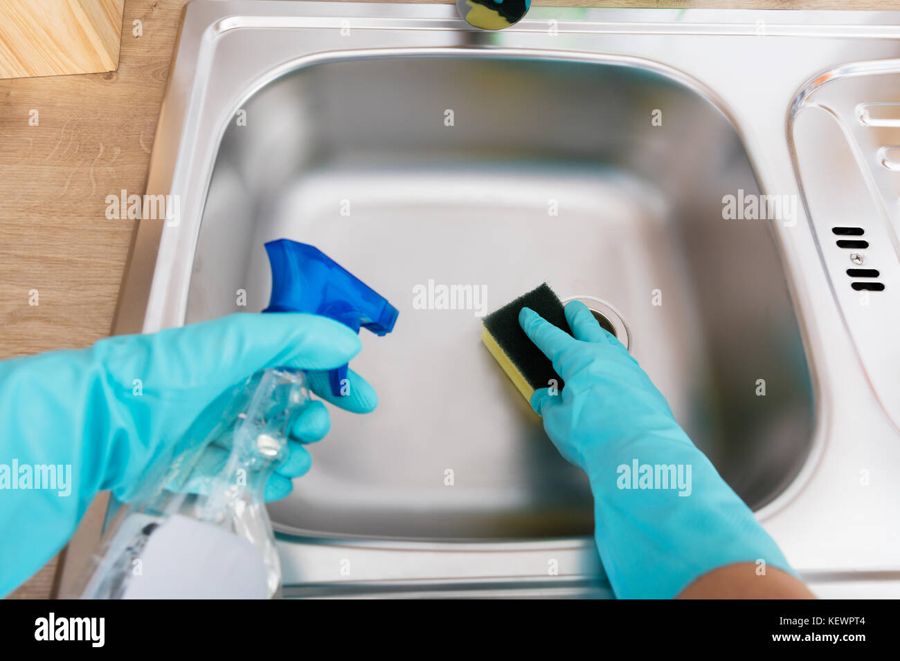 Close-up Of Person Hands Cleaning Kitchen Sink With Spray Bottle And ...