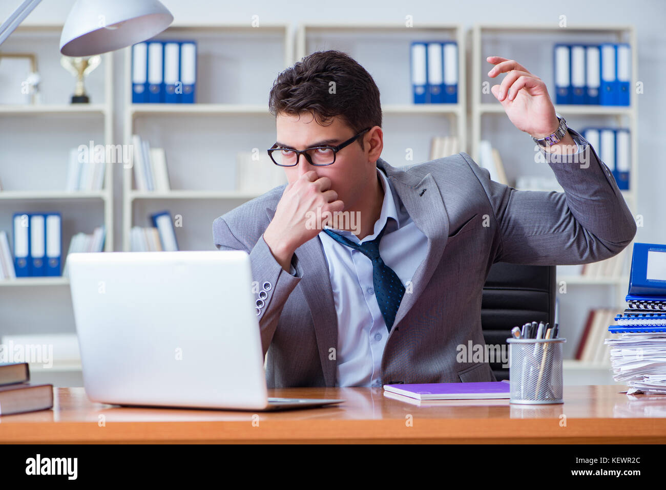 Businessman sweating excessively smelling bad in office at workplace ...