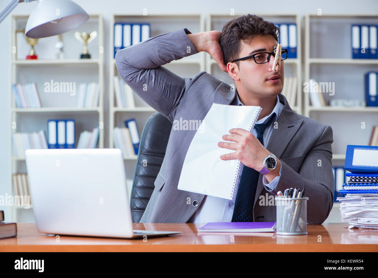 Businessman sweating excessively smelling bad in office at workplace ...