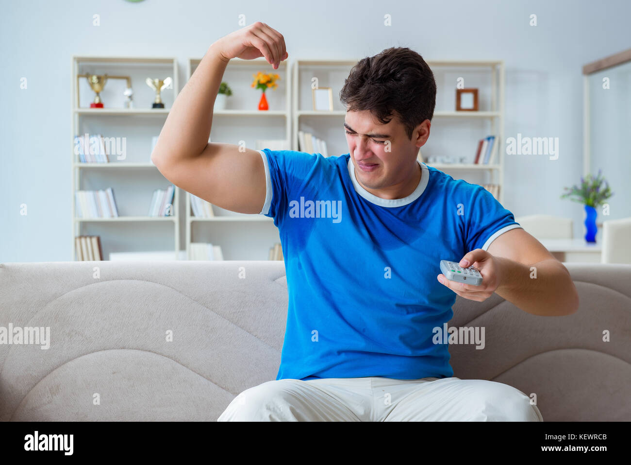 Man sweating excessively smelling bad at home Stock Photo - Alamy