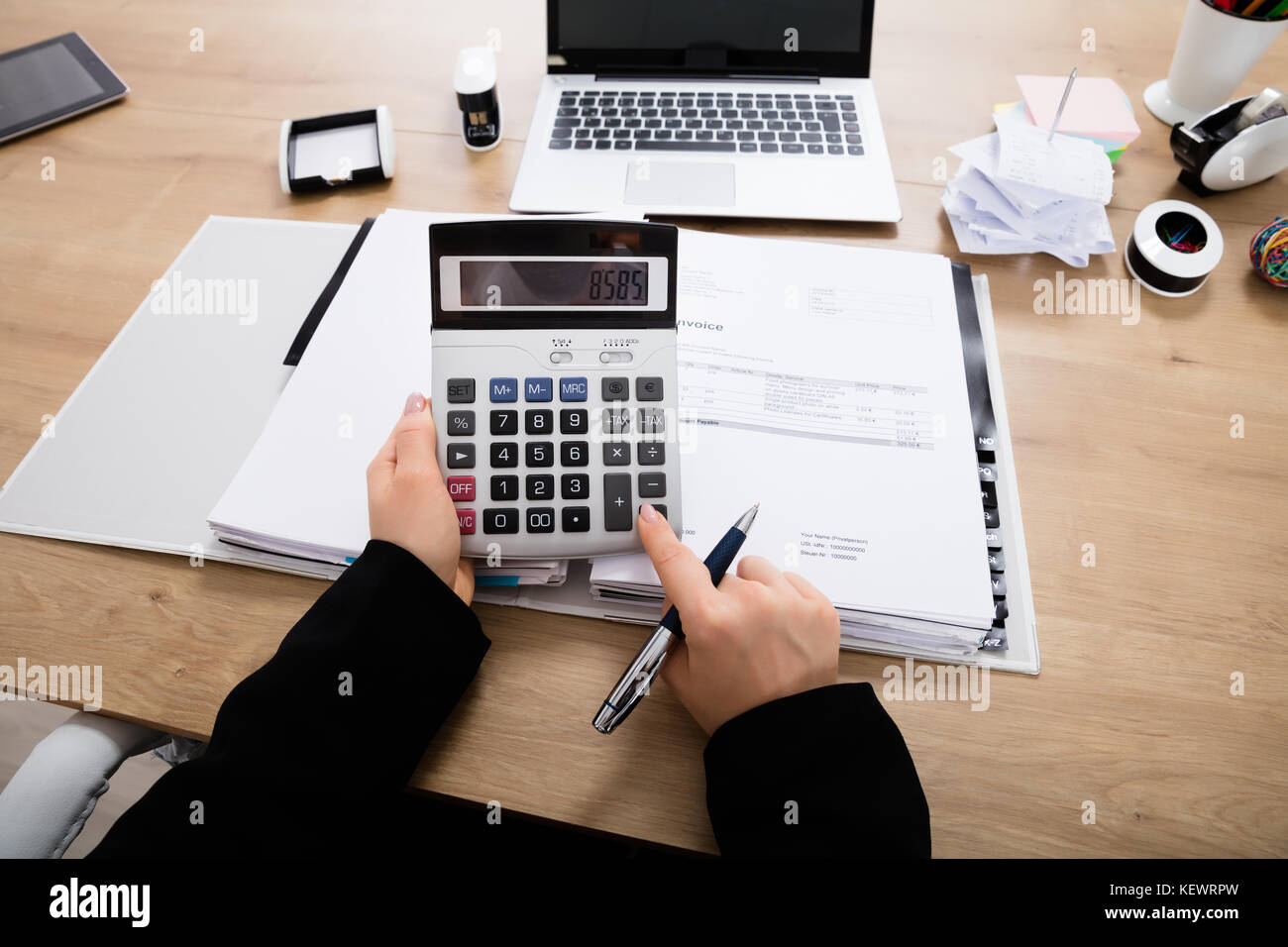 Close-up Of A Accountant Calculating Invoice Using Calculator On Office ...