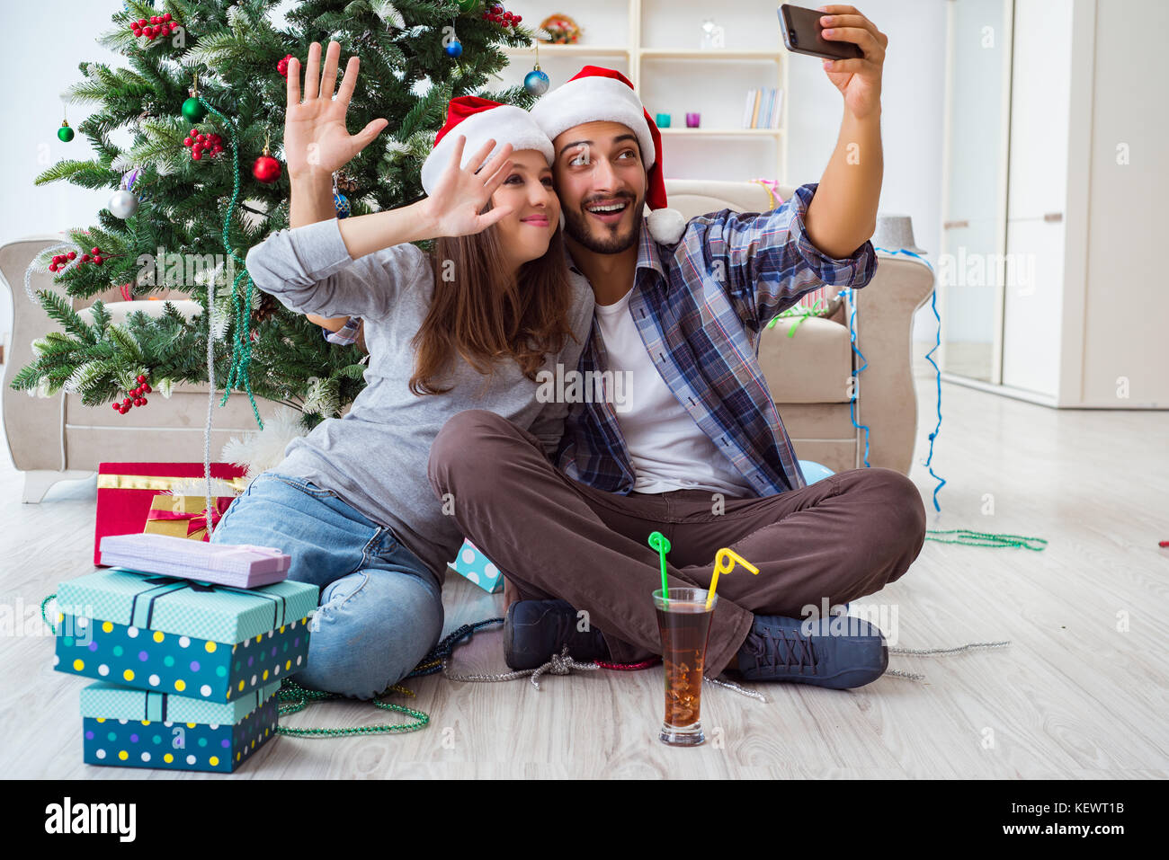 Young pair taking selfies during christmas Stock Photo - Alamy