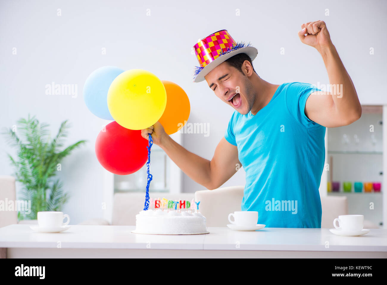 Young man celebrating birthday alone at home Stock Photo - Alamy