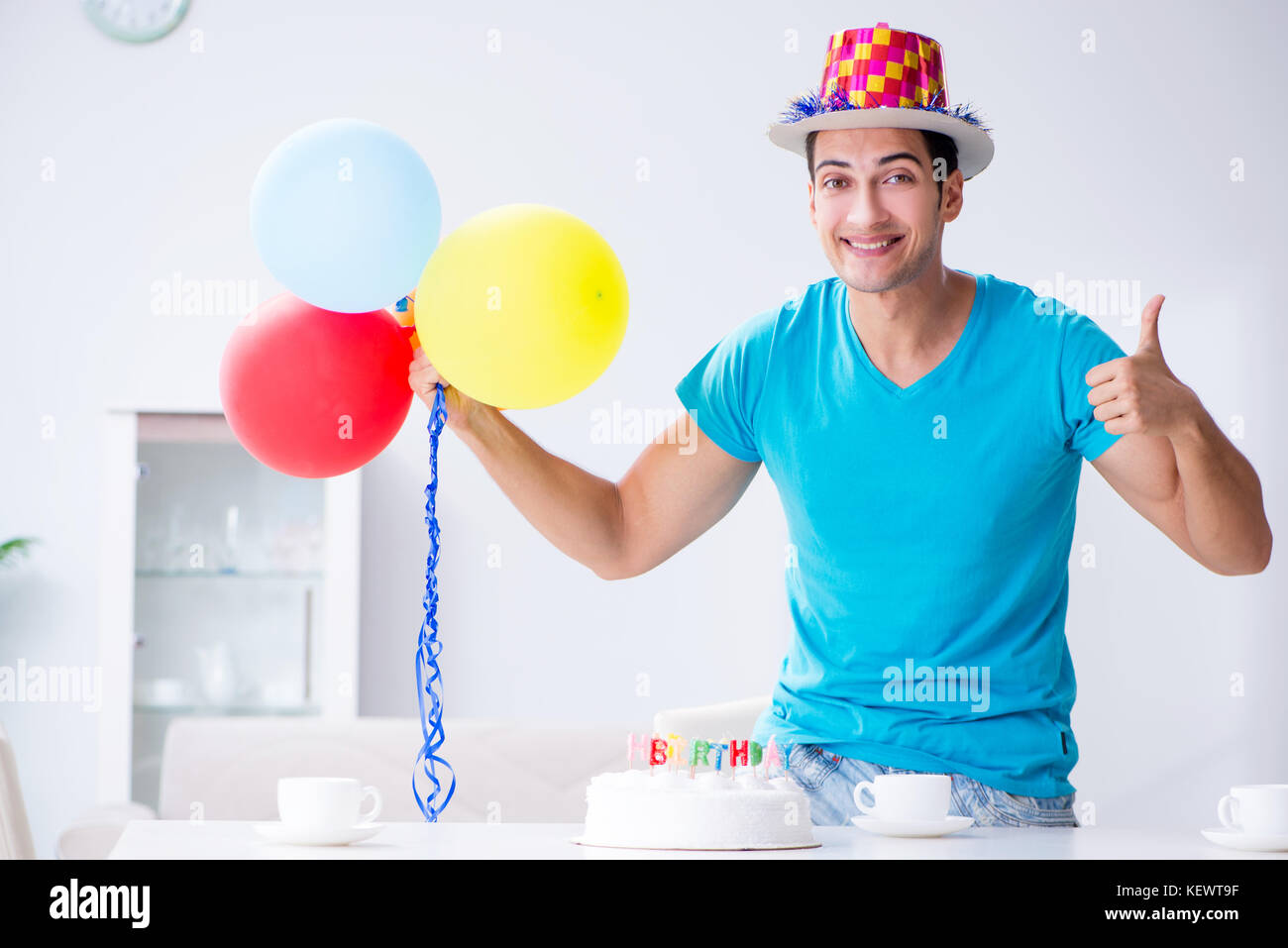 Young man celebrating birthday alone at home Stock Photo - Alamy