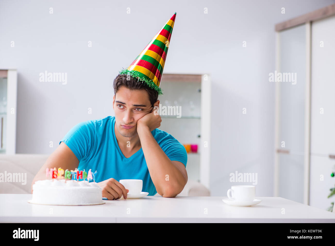 Young man celebrating birthday alone at home Stock Photo - Alamy