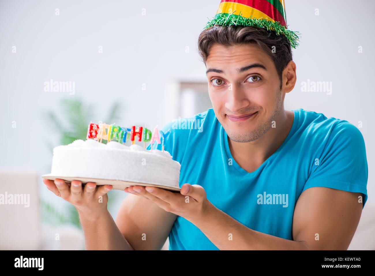 Young man celebrating birthday alone at home Stock Photo - Alamy