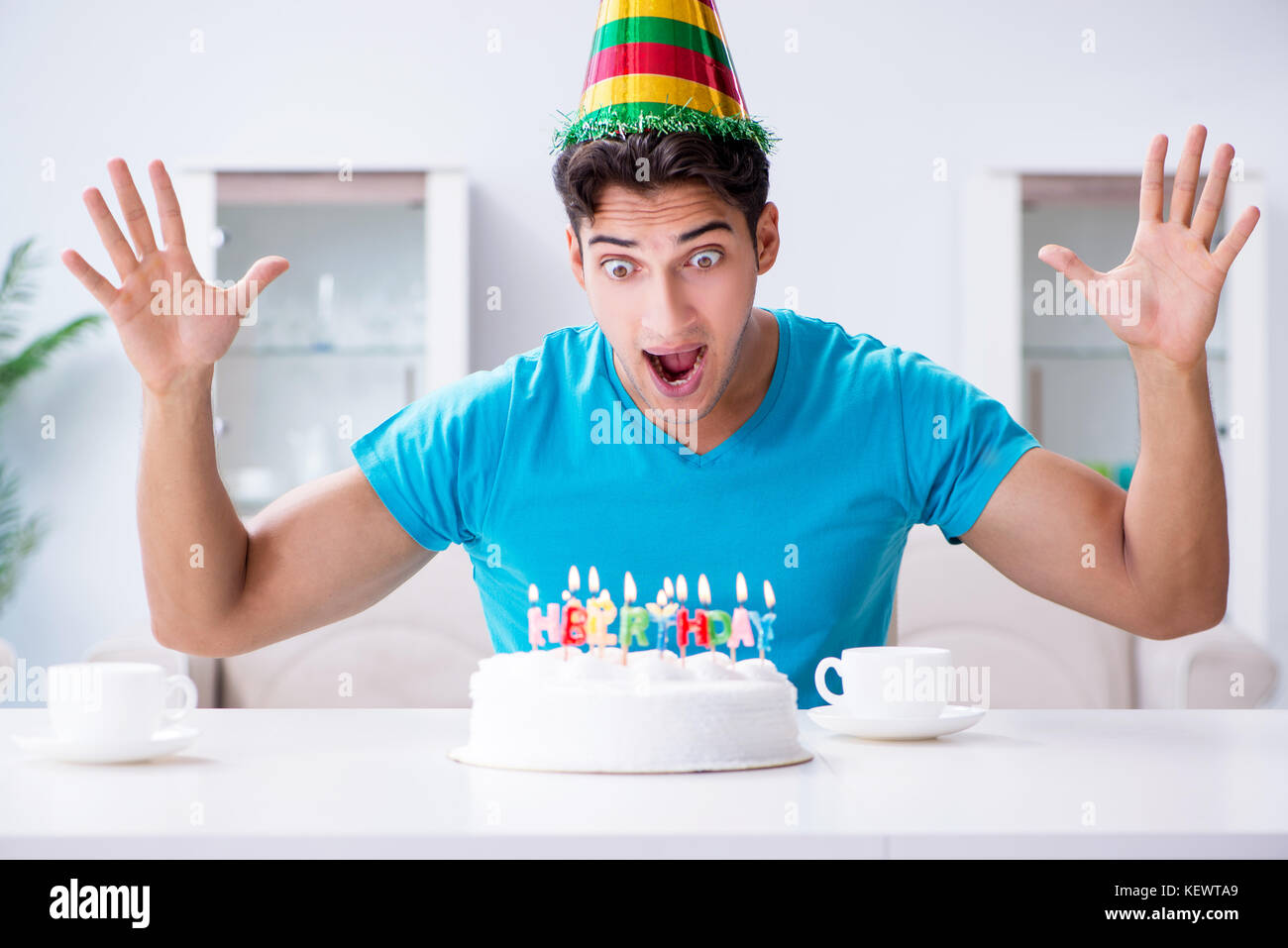 Young man celebrating birthday alone at home Stock Photo - Alamy