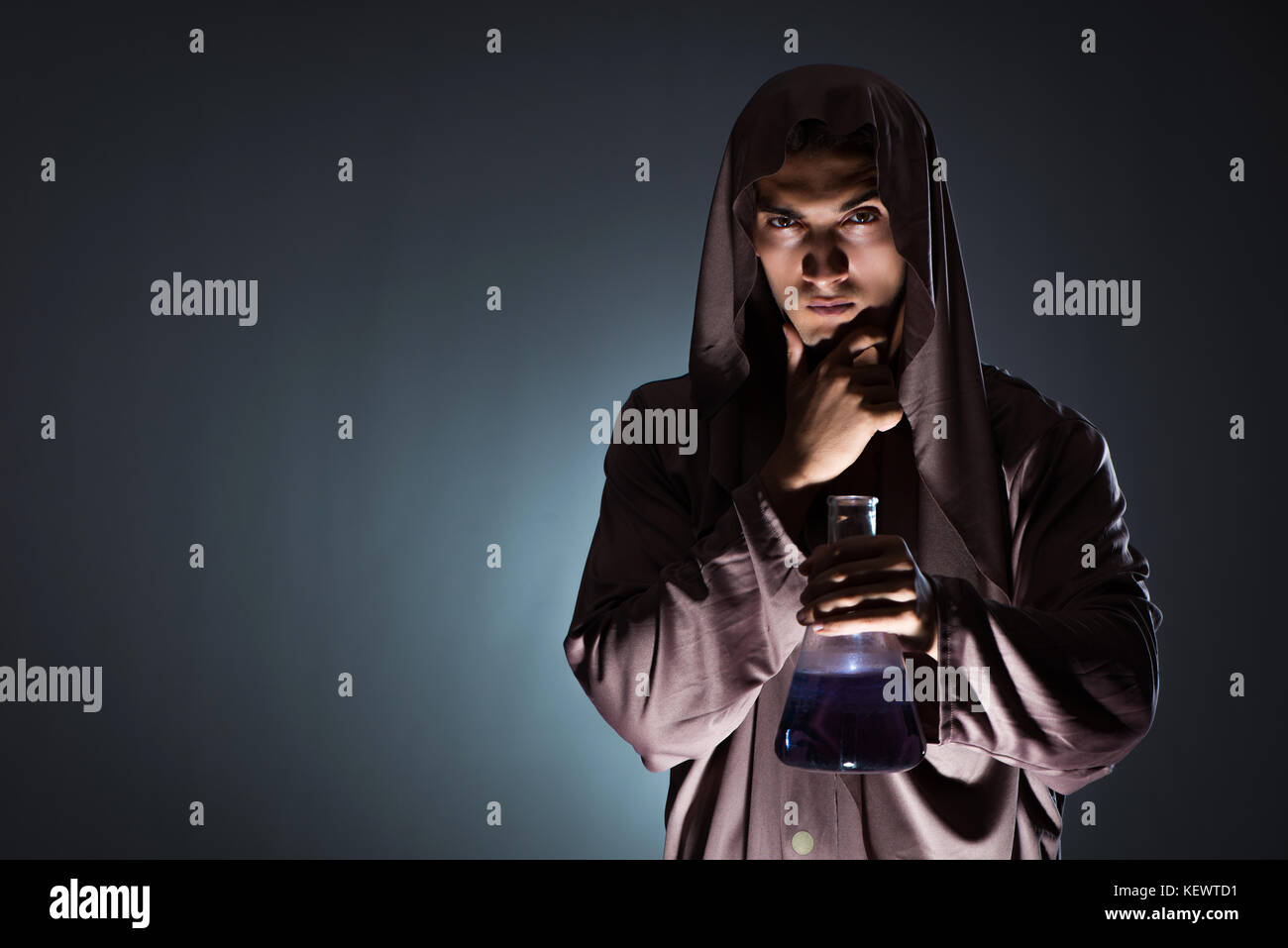 Alchemist doing experiments in alchemy concept Stock Photo - Alamy