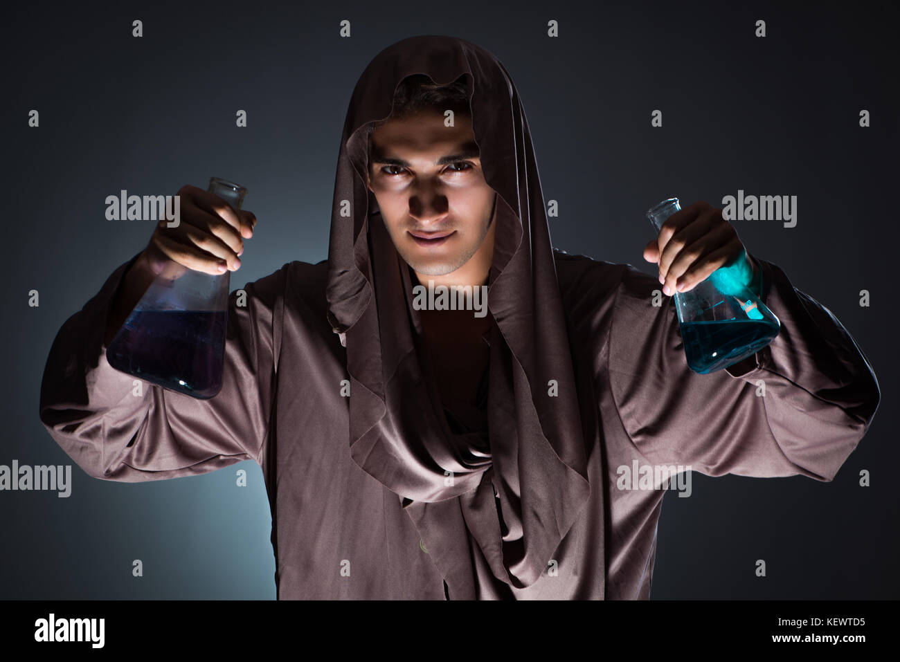 Alchemist doing experiments in alchemy concept Stock Photo - Alamy