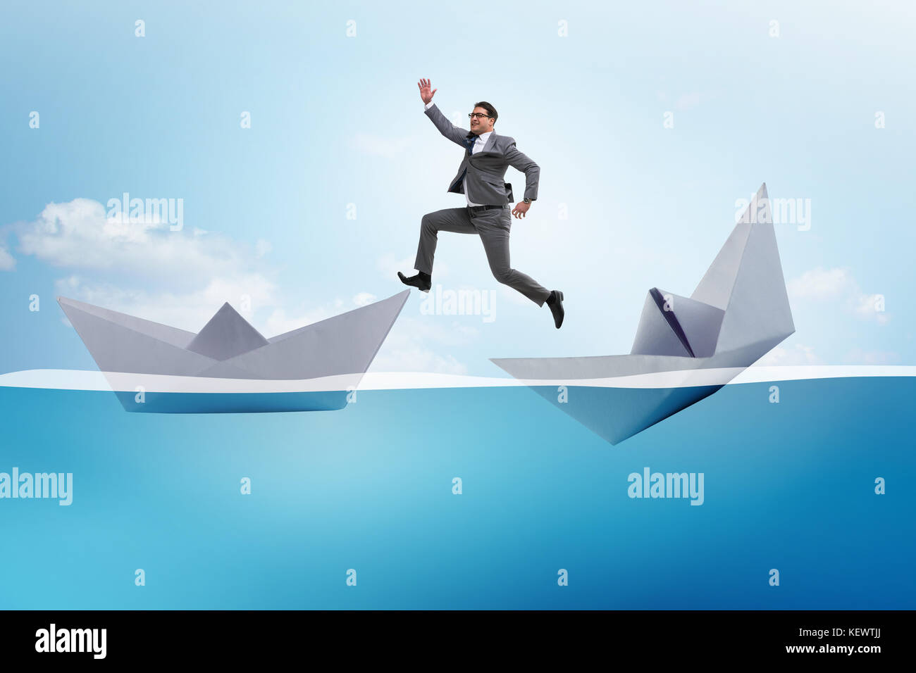 Businessman escaping sunken paper boat ship Stock Photo - Alamy