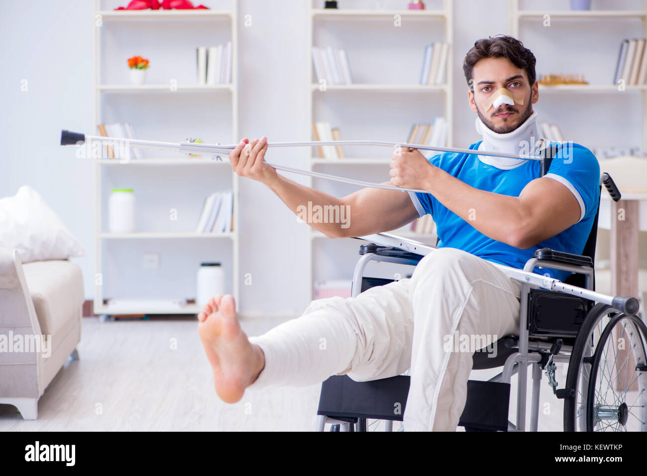 Injured young man recovering at home Stock Photo - Alamy