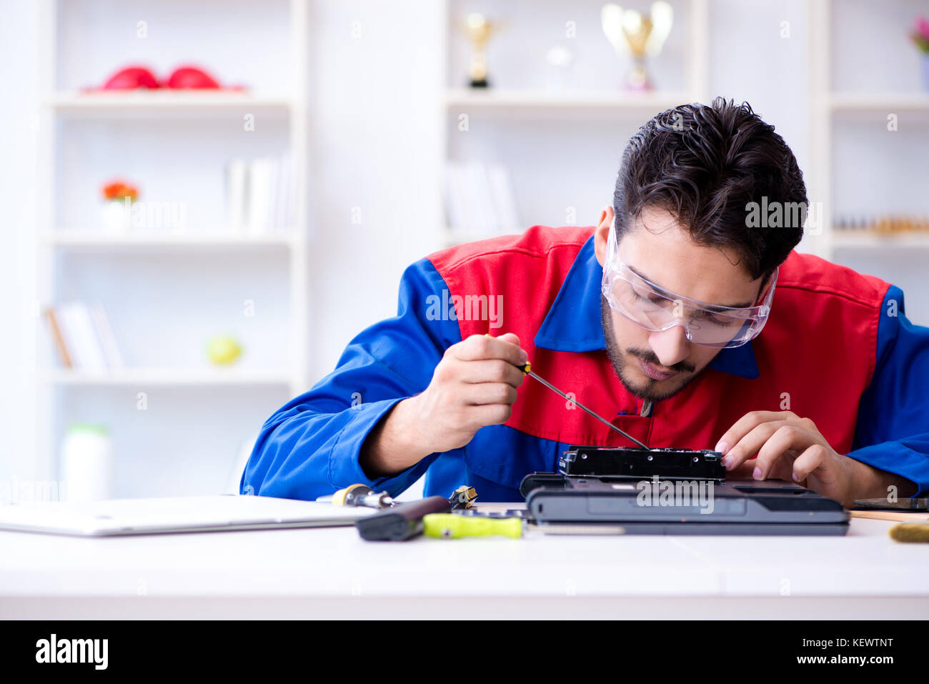 Repairman working in technical support fixing computer laptop ...