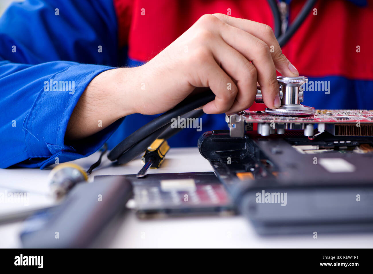 Repairman working in technical support fixing computer laptop ...